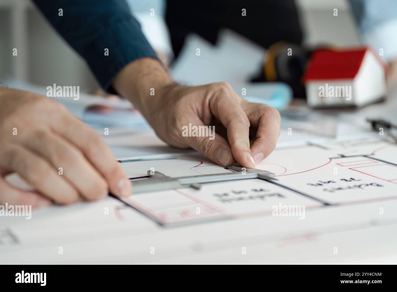 Architect's Hands Working on Blueprint with Scale Ruler and Model House ...