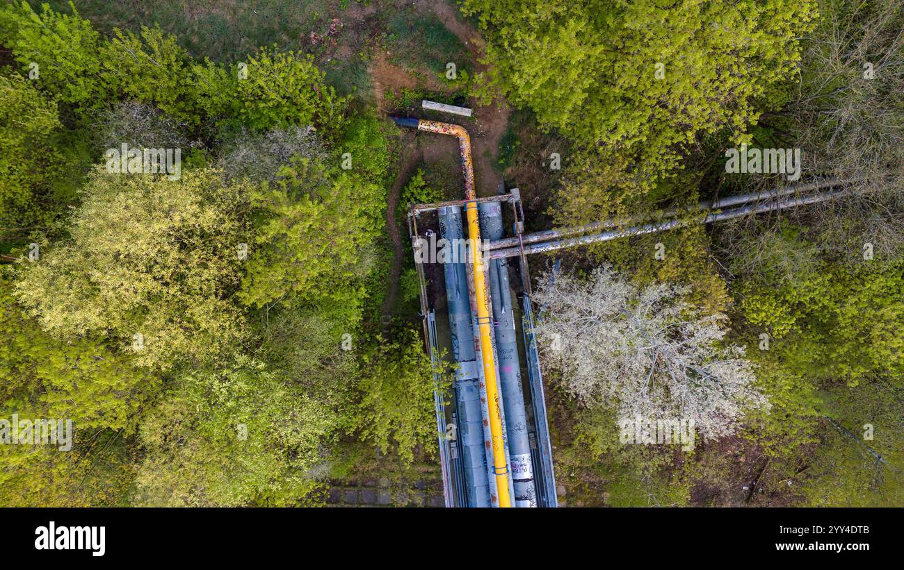 Aerial view of a pipeline running through a lush green forest ...
