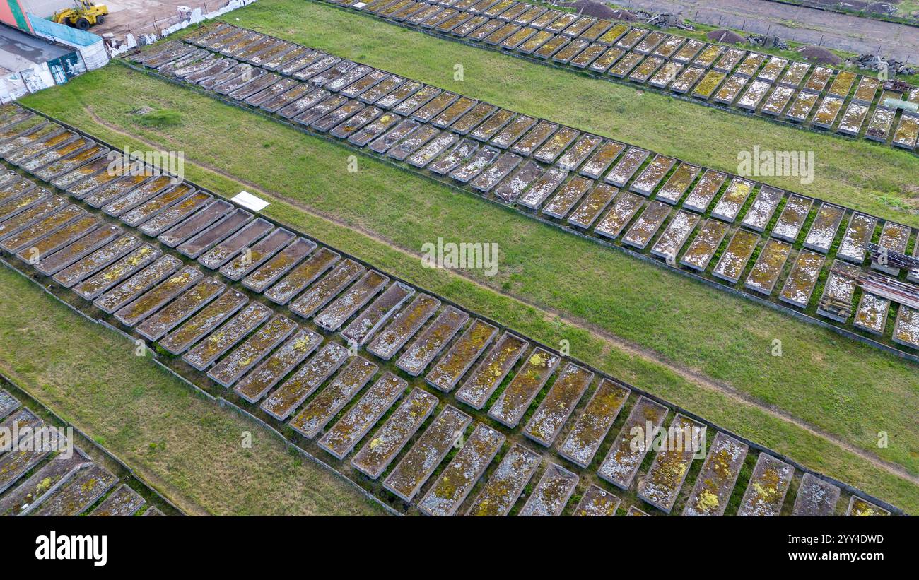 Aerial view of a large field with rows of rectangular old concrete ...