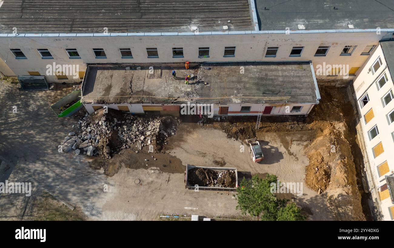 Aerial view of a construction site with workers on a partially ...