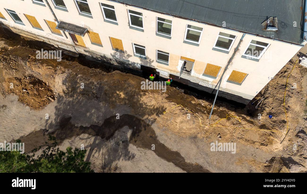 Aerial view of a building with boarded windows and ongoing construction ...
