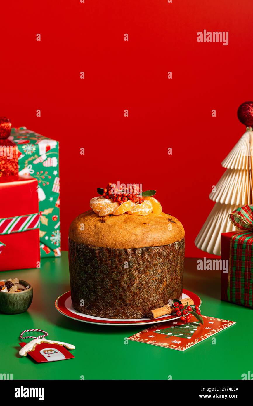A beautifully decorated panettone sits on a vibrant green surface with ...