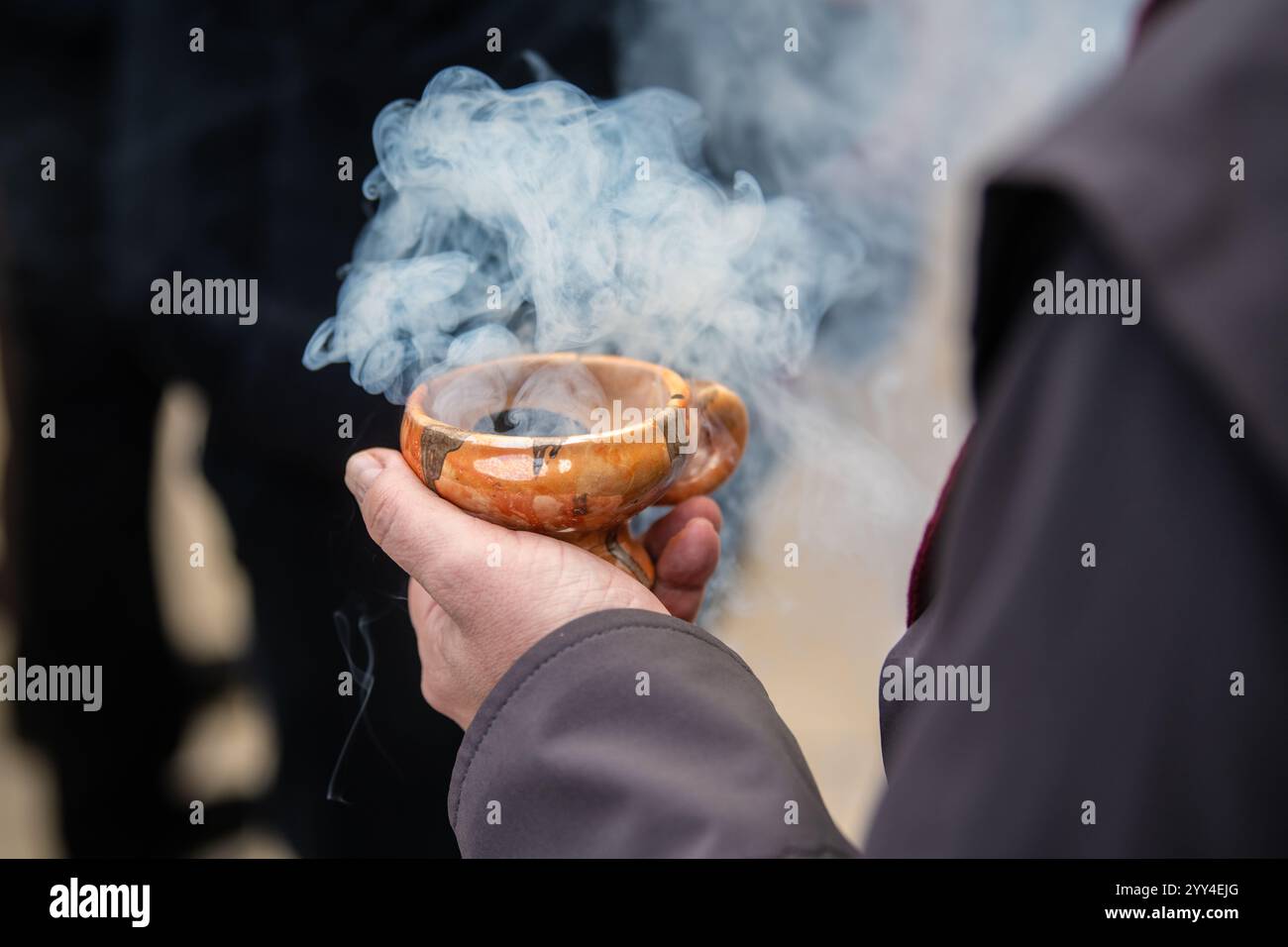 Closeup of the hand of an orthodox priest holding a censer, incense ...