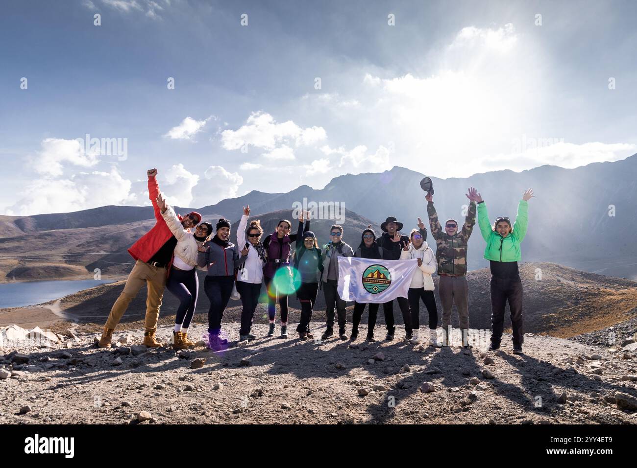 A joyful group of hikers celebrates their accomplishment at a mountain ...