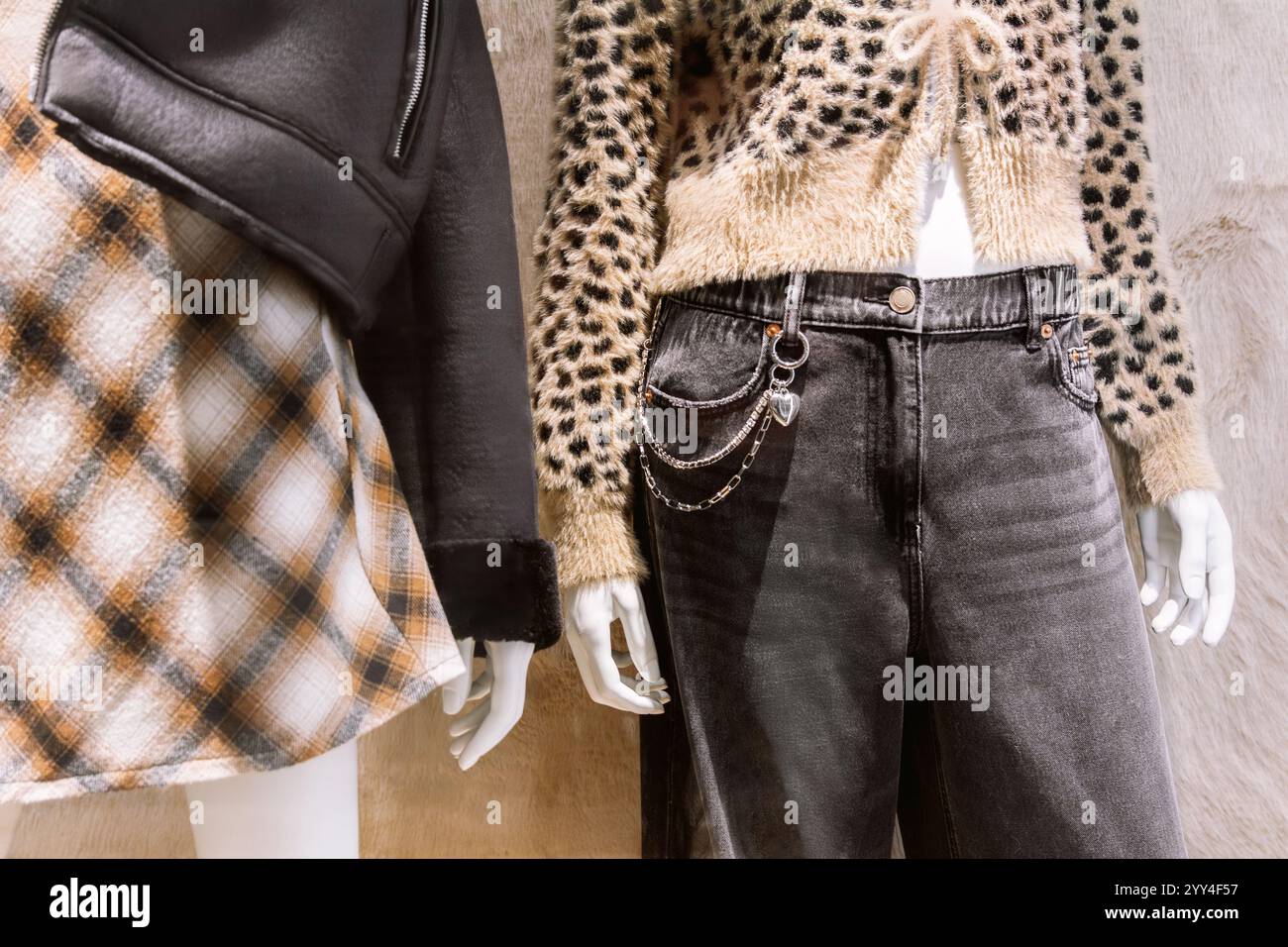 A chic display featuring two mannequins dressed in trendy outfits ...