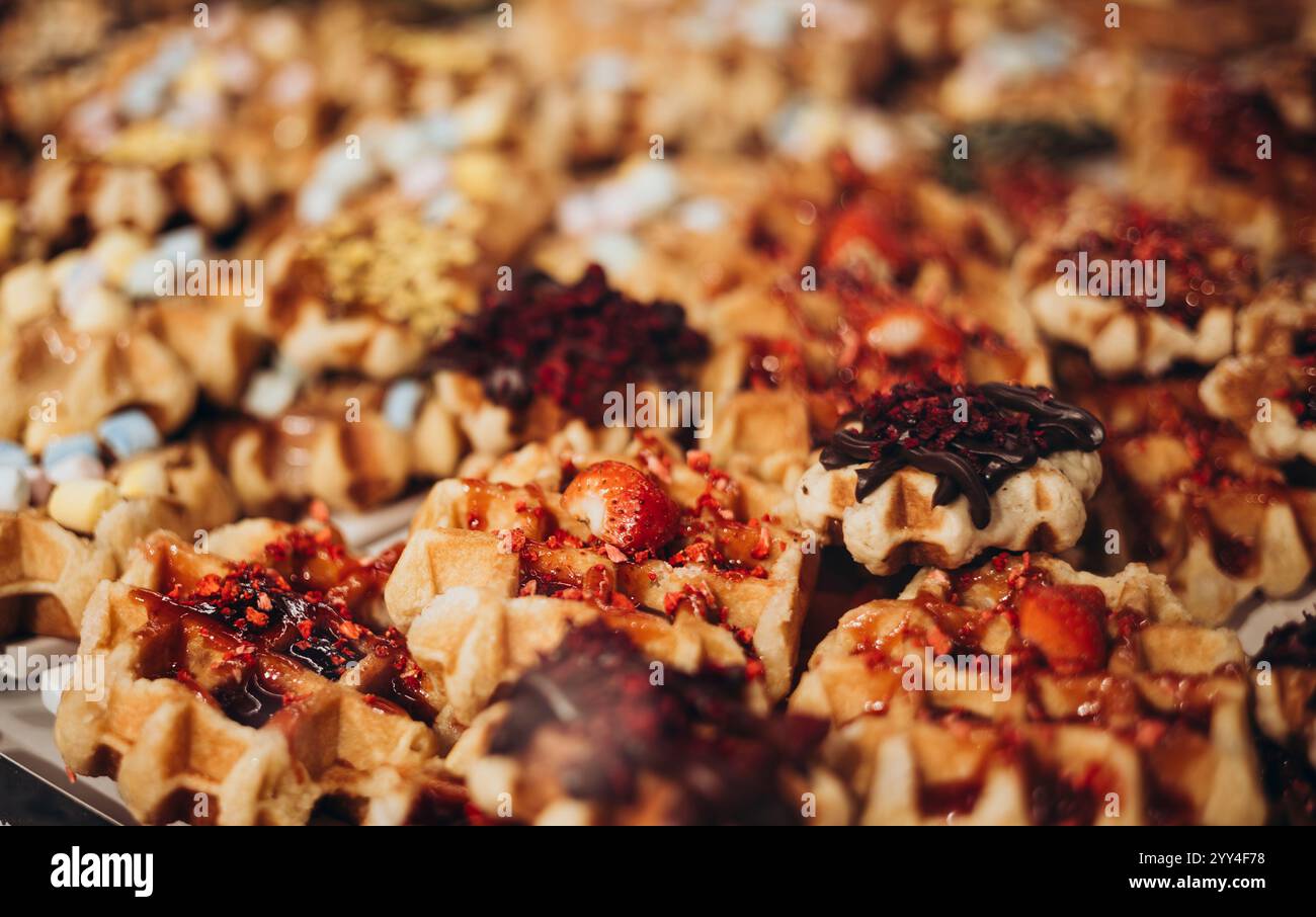 A tempting display of waffles adorned with chocolate, strawberries, and ...