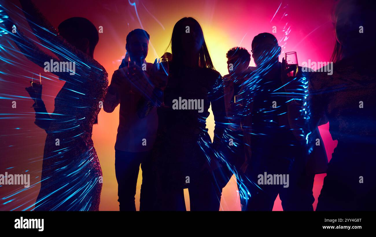 Friends raise glasses high, celebrating holidays in neon lights, dance ...