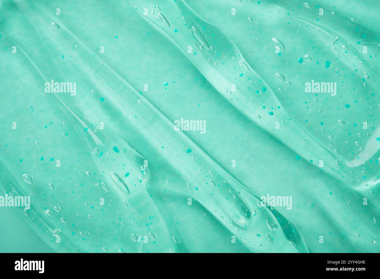 A close-up of translucent aqua blue gel textures featuring delicate ...