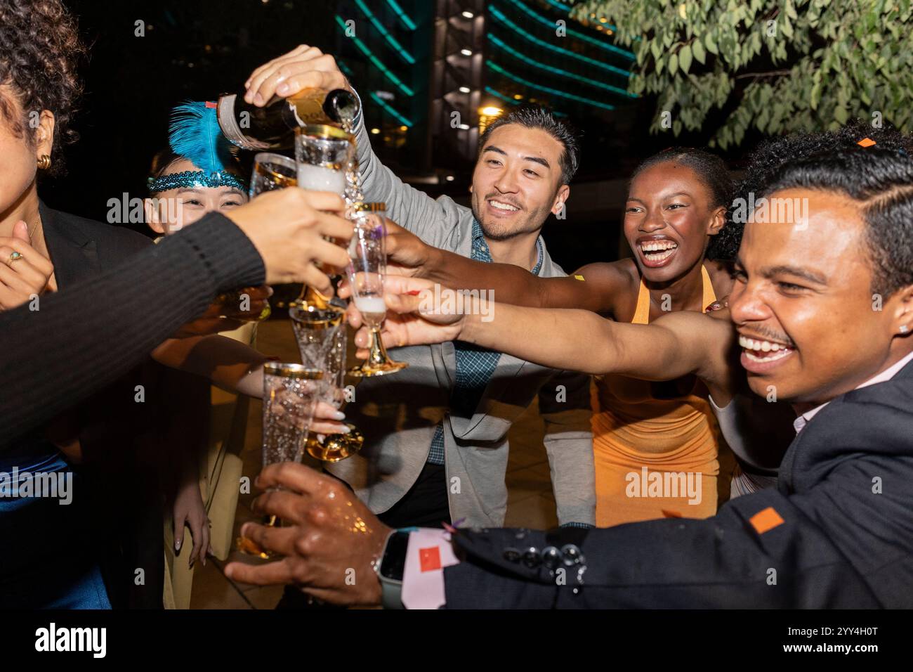 A lively group of friends celebrating together at a city nightlife ...