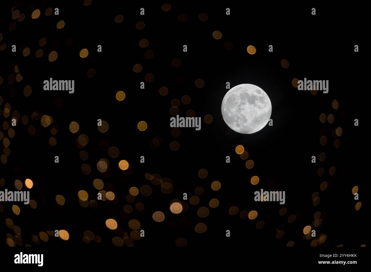 A captivating view of the full moon, captured, surrounded by glittering ...