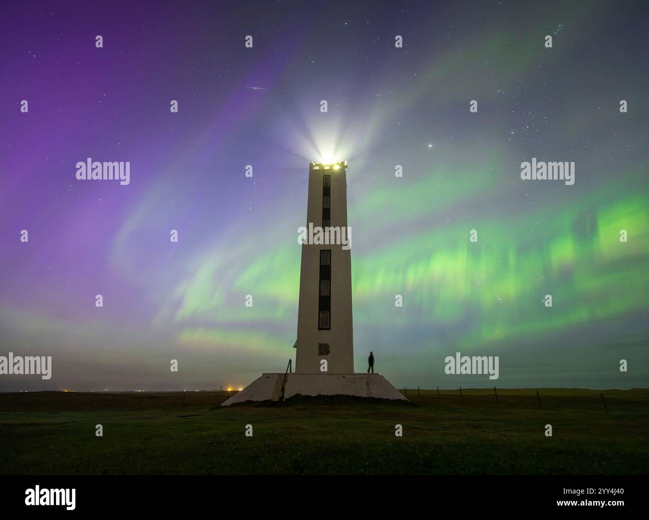 The northern lights paint the sky in vivid green and purple hues above ...