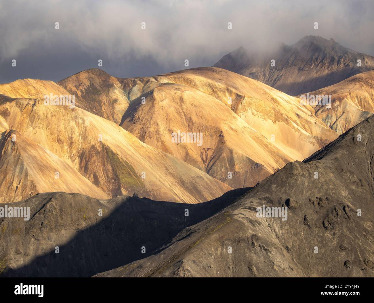 An awe-inspiring view of golden-hued peaks in Iceland, with dramatic ...