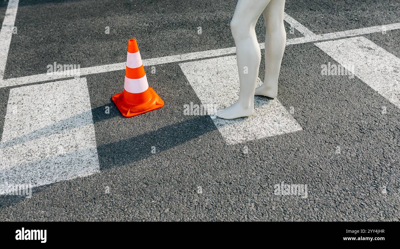 Urban scene showing a traffic cone on a pedestrian crossing, with ...
