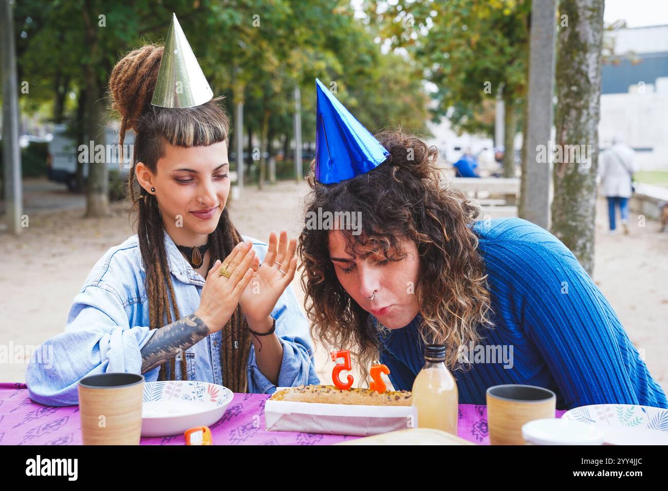 A transgender couple enjoying a birthday celebration at an outdoor ...