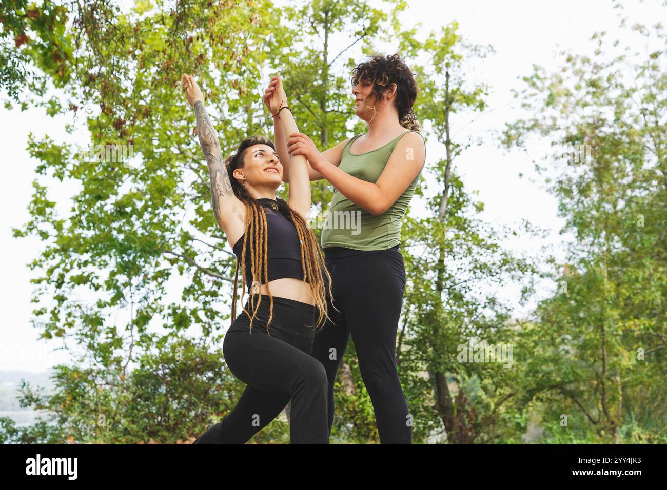 A transgender couple shares a moment in a natural setting. The ...