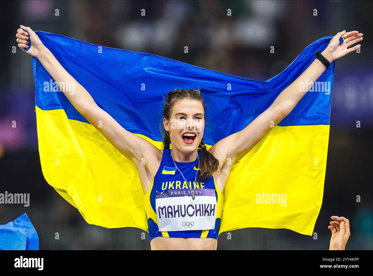 Yaroslava Mahuchikh celebrating her medal with her country's flag at ...