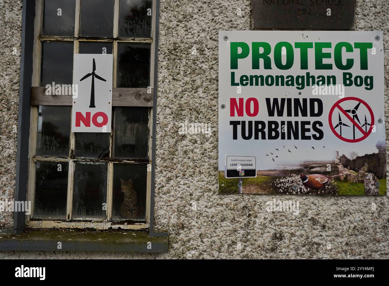 Protest banners against wind turbines displayed on a building in ...