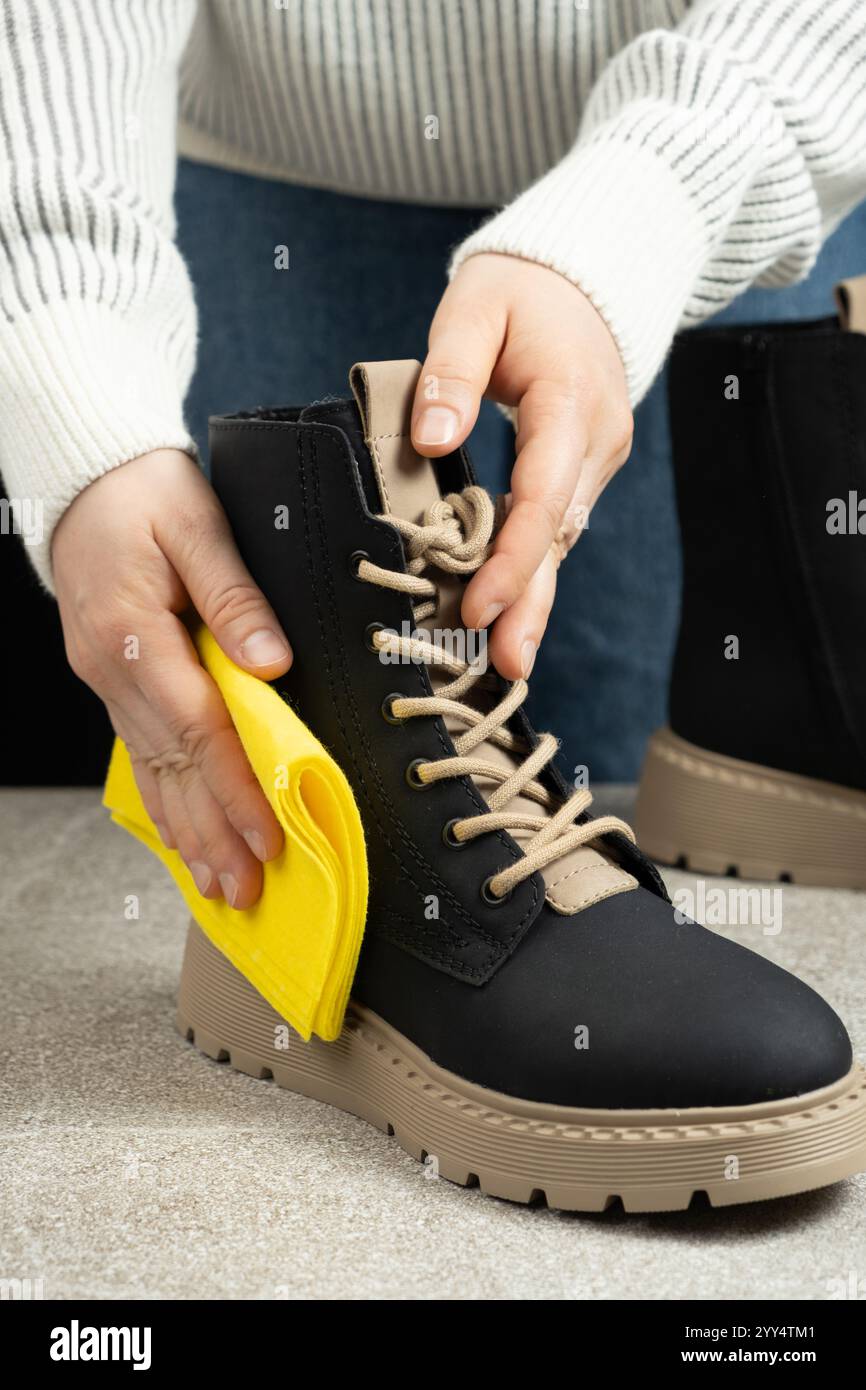 Shoe Care, Woman Wiping Cloth Surface Of Leather Shoe Stock Photo - Alamy