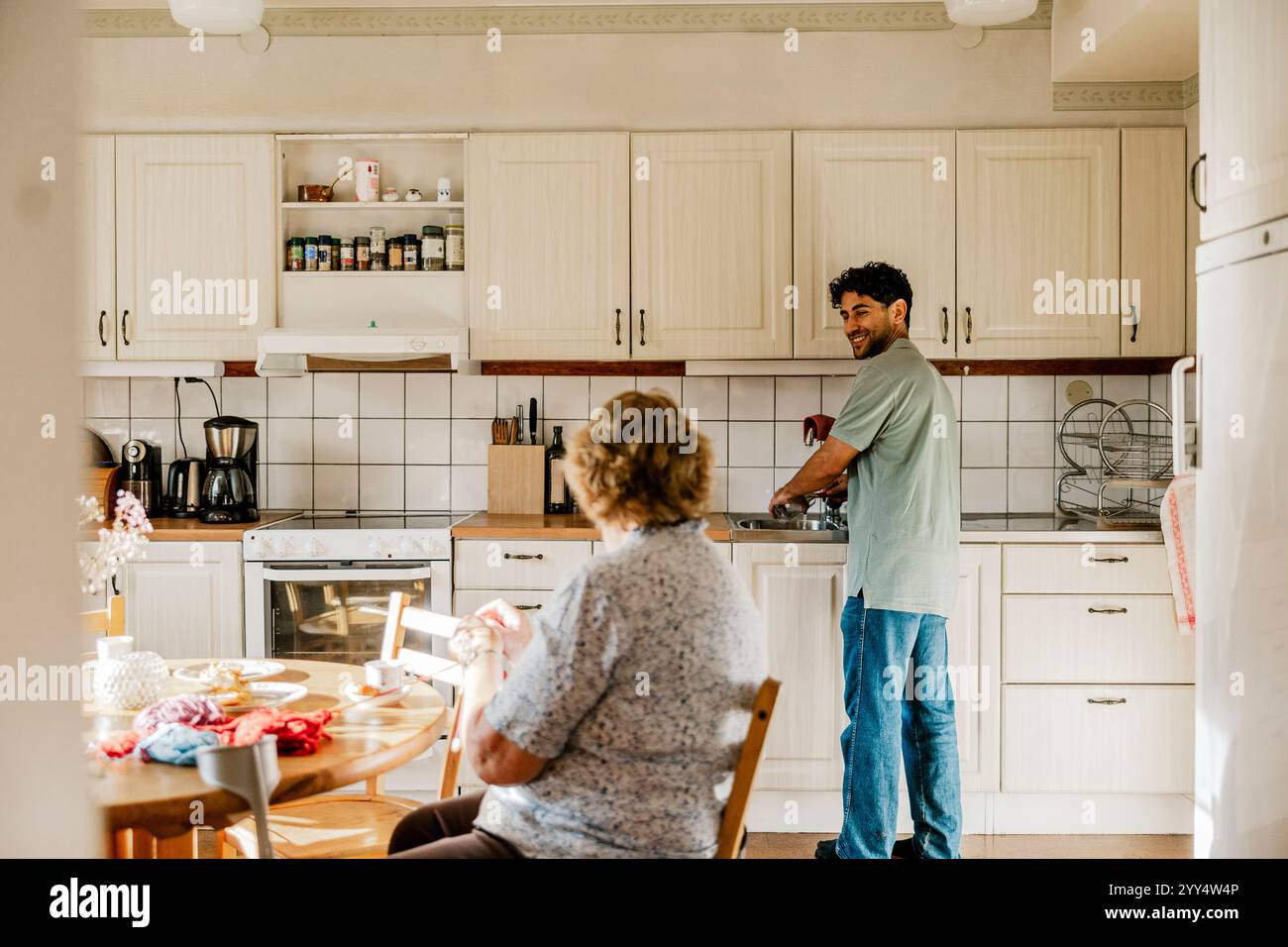 Male caregiver washing dishes senior hi-res stock photography and ...