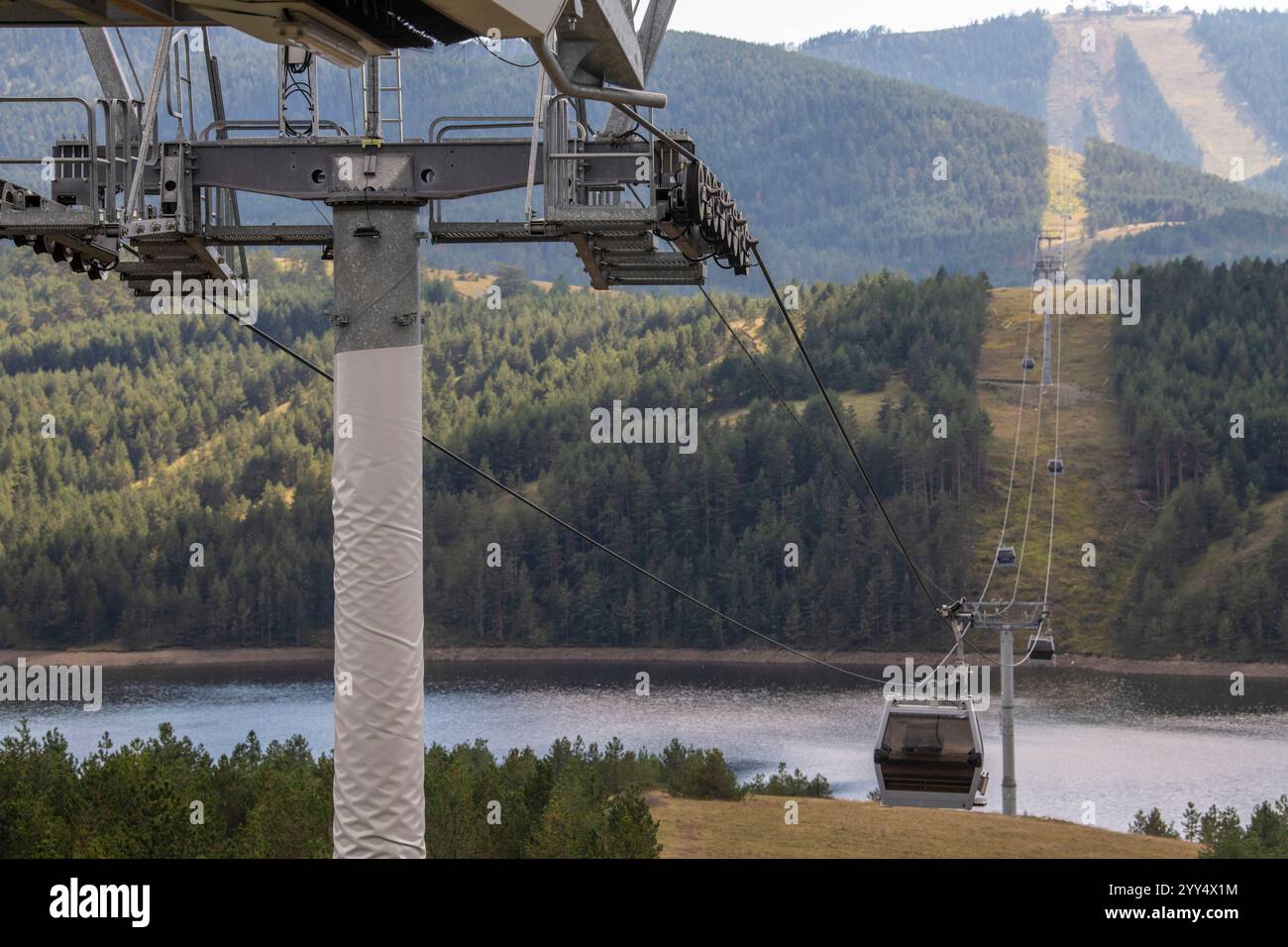 Cable car machinery mechanism mounted high above mountain, farmlands ...