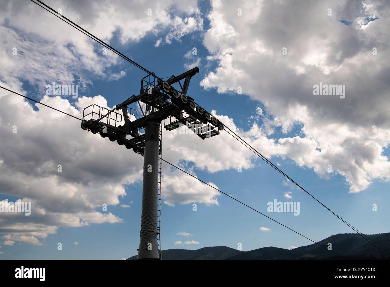 Cable car machinery mechanism mounted high above mountain, farmlands ...