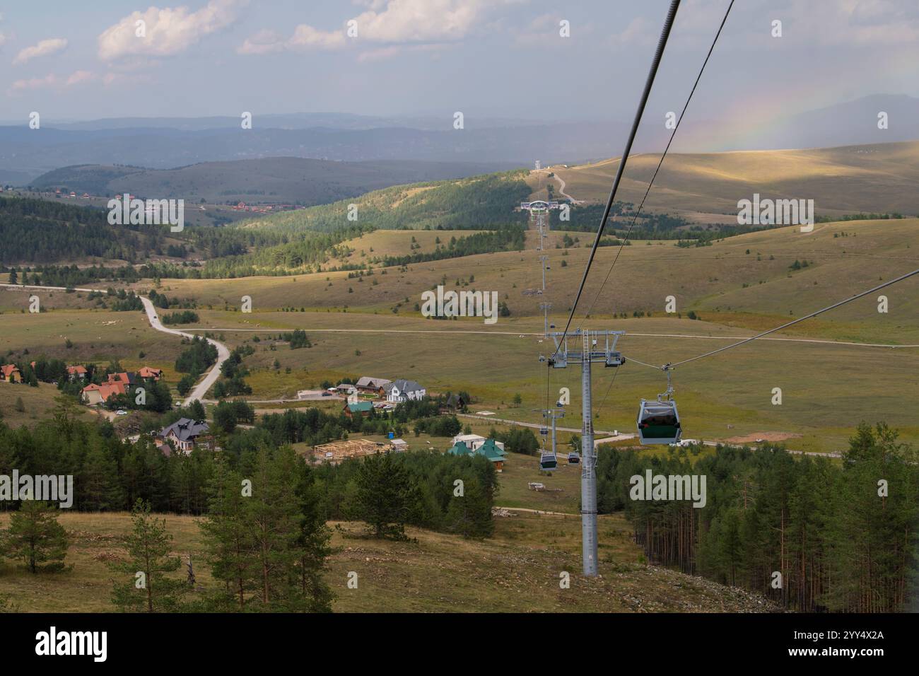Cable car machinery mechanism mounted high above mountain, farmlands ...
