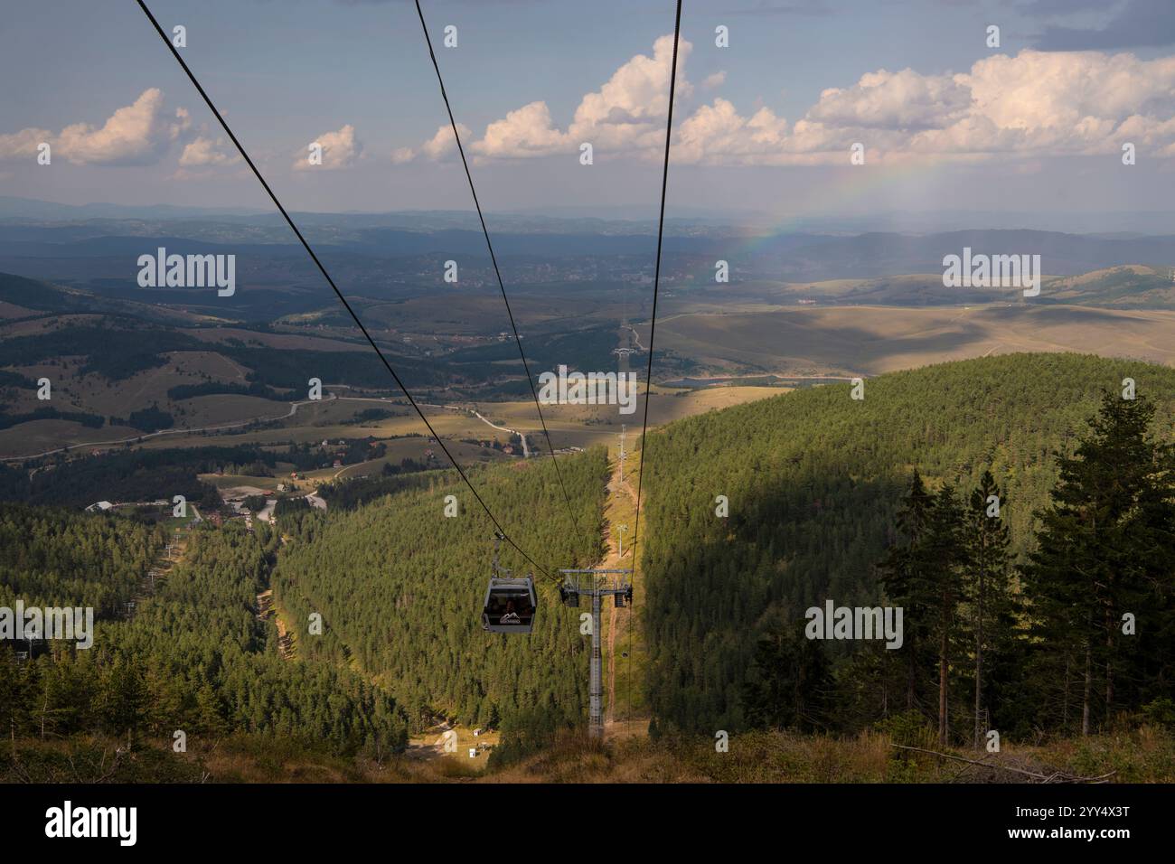 Cable car machinery mechanism mounted high above mountain, farmlands ...