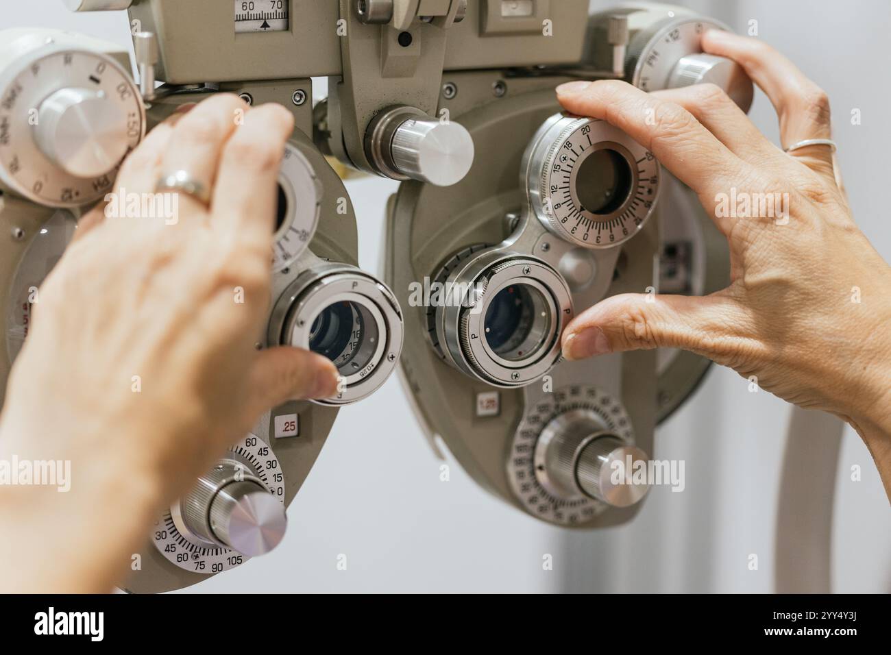 Optometrist adjusting trial frame for eye examination Stock Photo - Alamy
