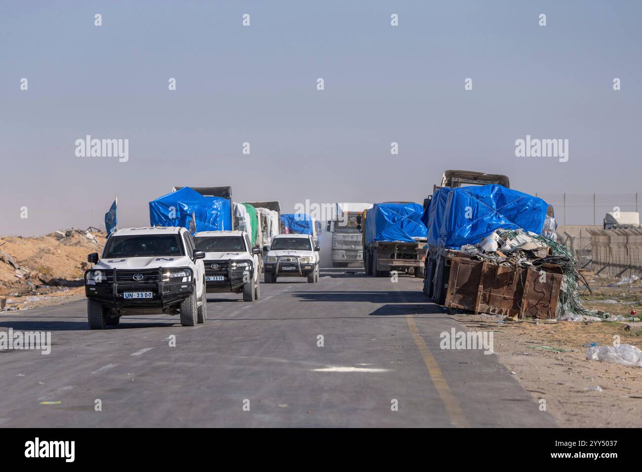 United Nations vehicles carrying aid drive along the Palestinian side ...