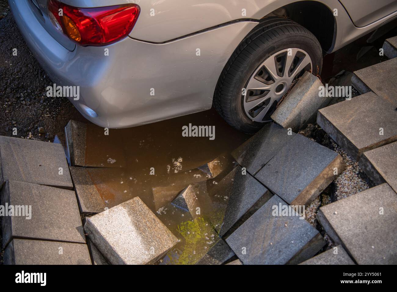 The car fell into a huge sinkhole on broken pavement road surface on ...