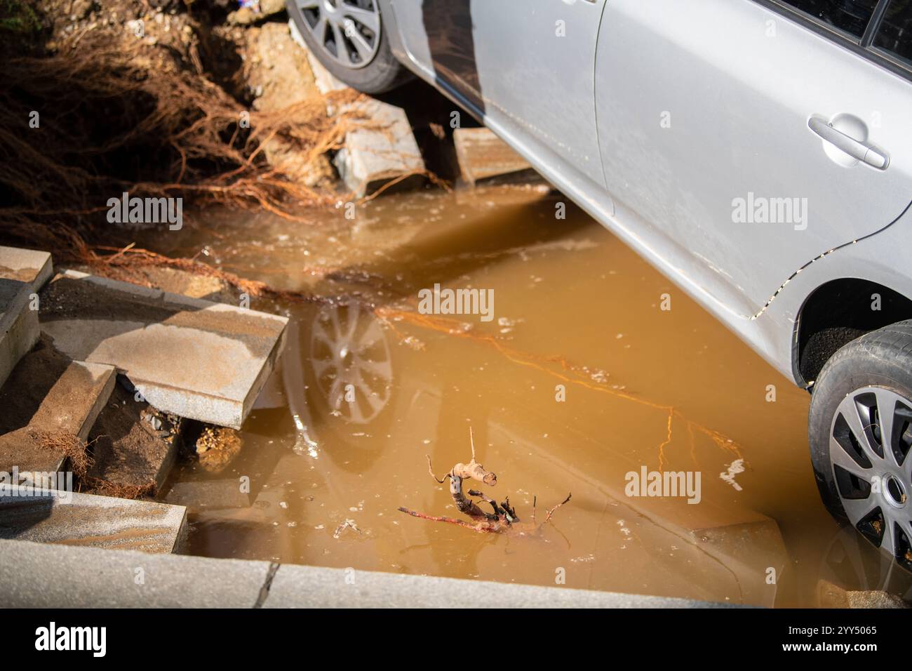 The car fell into a huge sinkhole on broken pavement road surface on ...