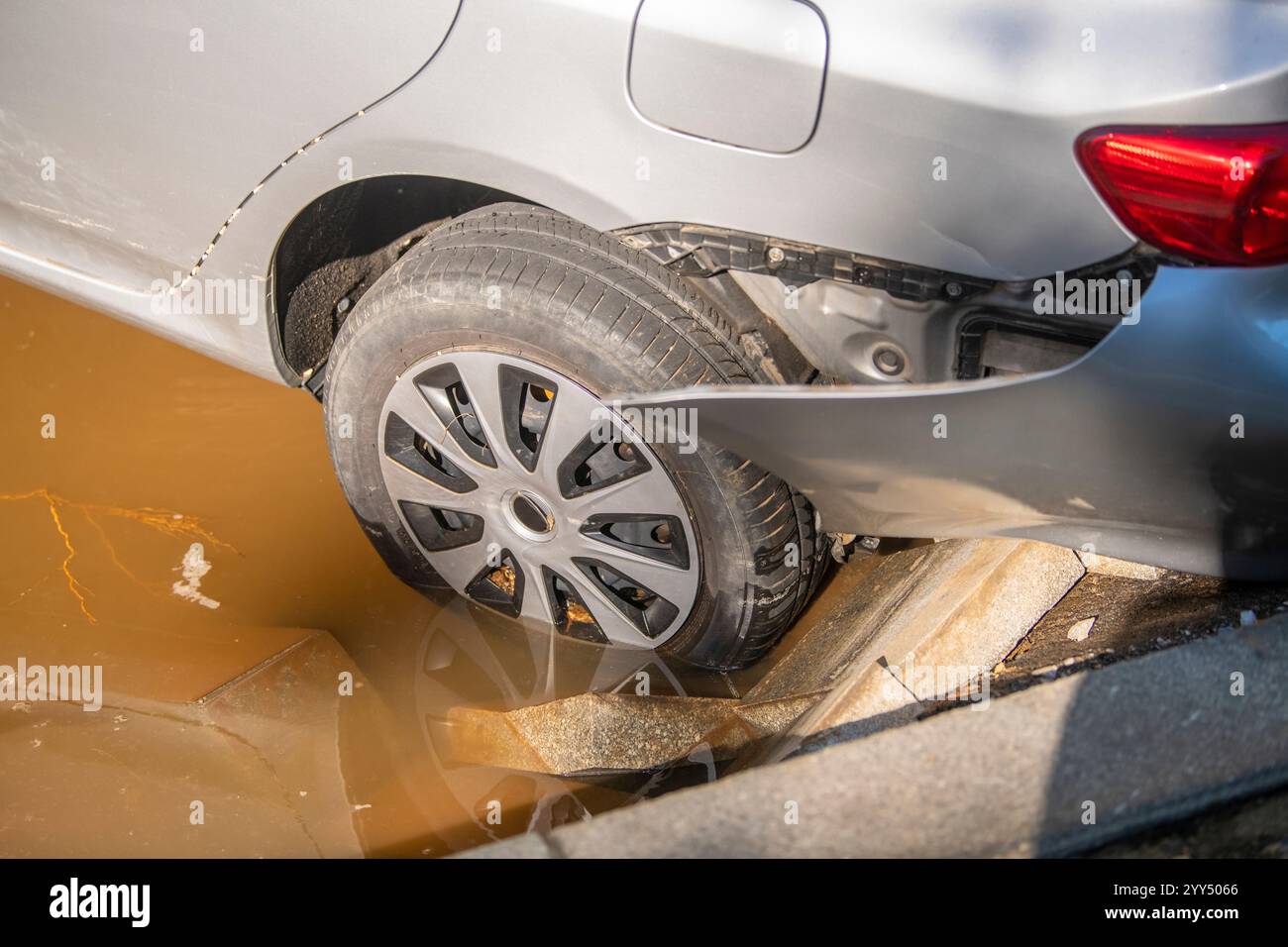 The car fell into a huge sinkhole on broken pavement road surface on ...