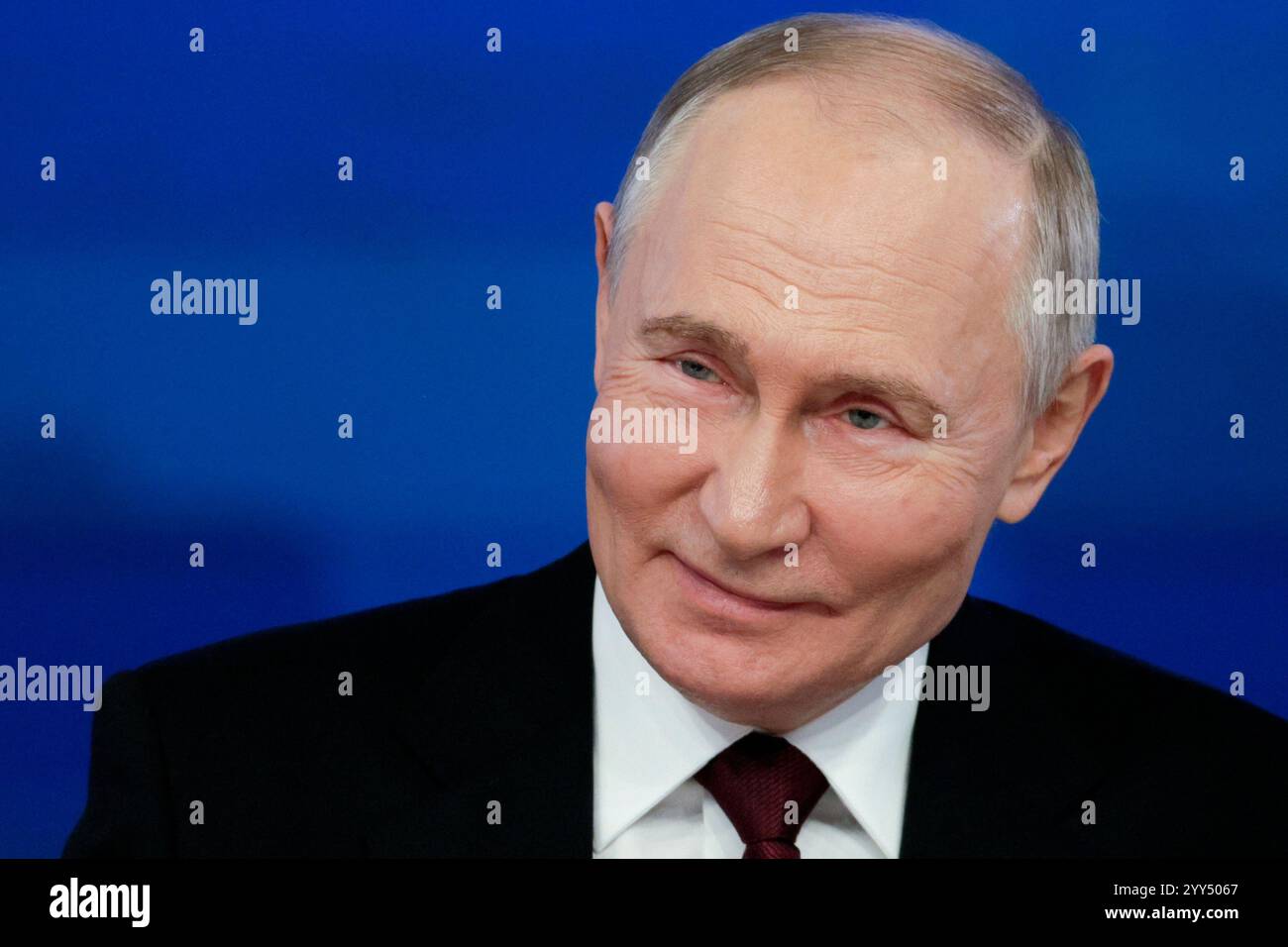 Russian President Vladimir Putin smiles during his annual news ...