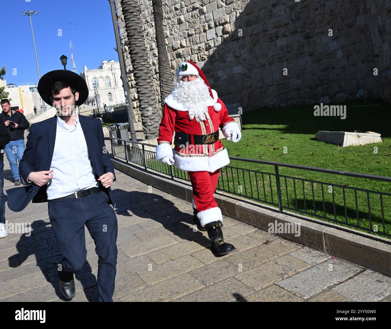 Old City Jerusalem, Israel. 19th Dec, 2024. An Orthodox Jewish man runs ...