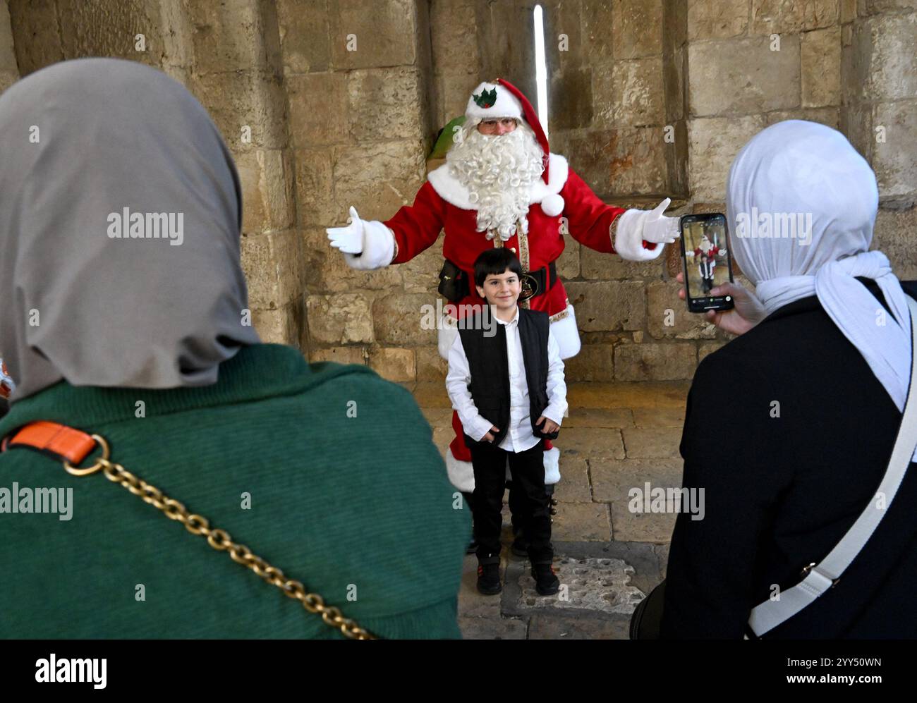 Old City Jerusalem, Israel. 19th Dec, 2024. A Palestinian Muslim woman ...