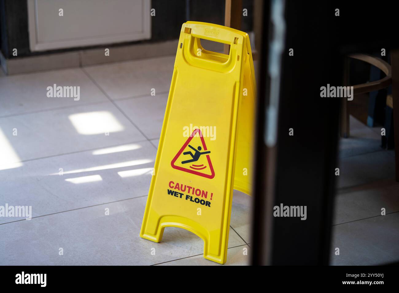Yellow sign showing warning of caution wet floor. Slippery sign on wet ...
