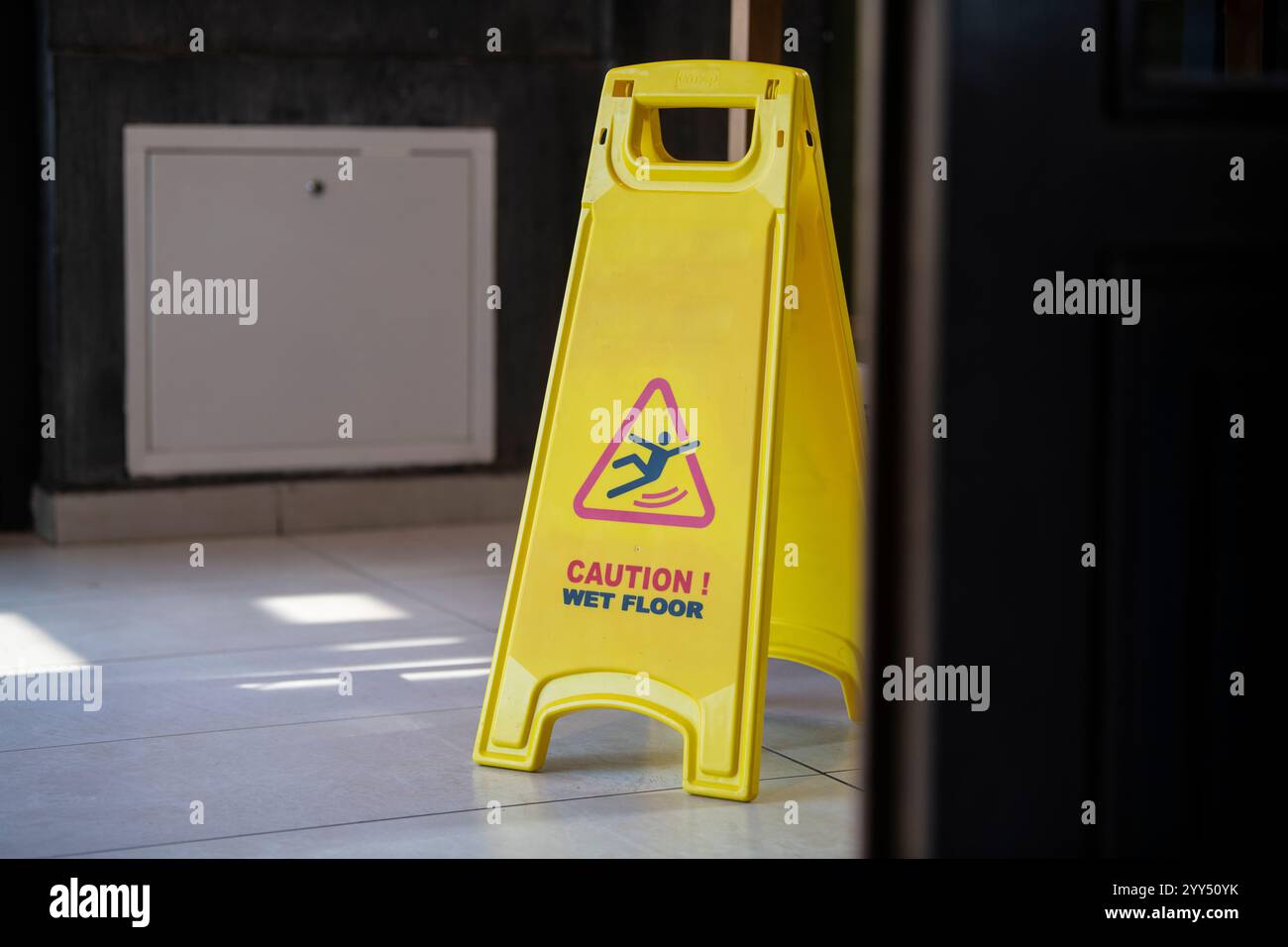 Yellow sign showing warning of caution wet floor. Slippery sign on wet ...