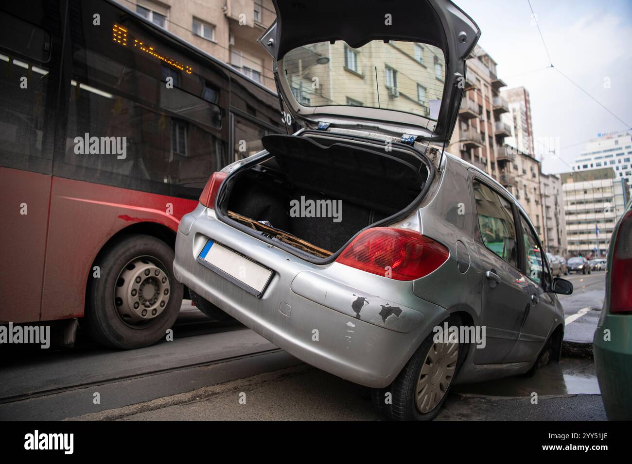 The car fell into a huge sinkhole on busy asphalt road surface on which ...