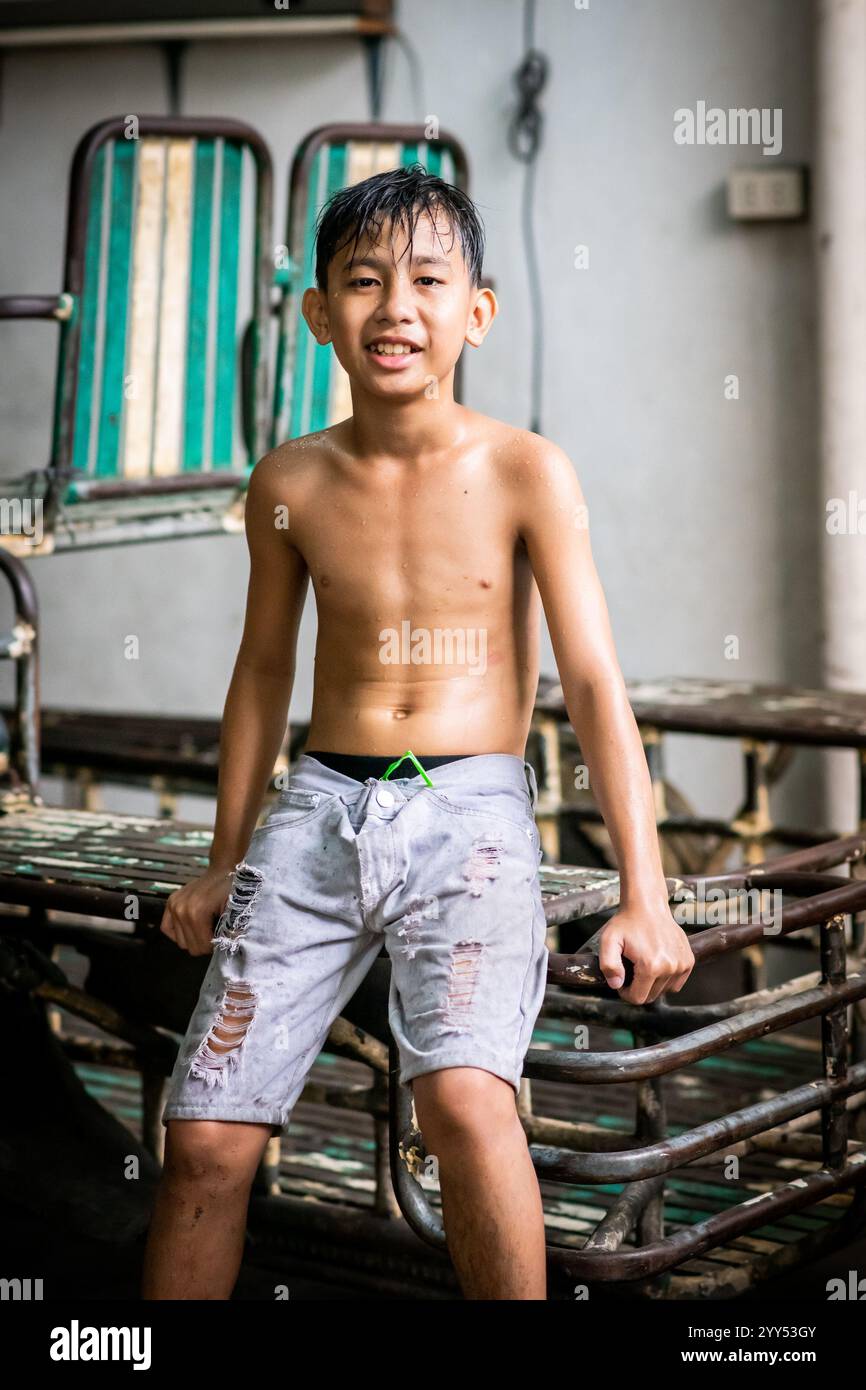 A young Filipino boy poses after a break from the rain in the Tondo ...