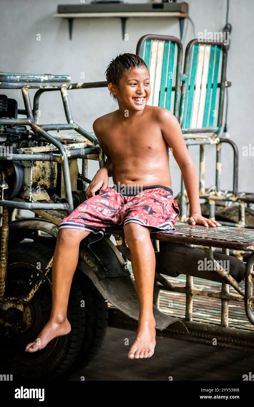 A young Filipino boy poses after a break from the rain in the Tondo ...
