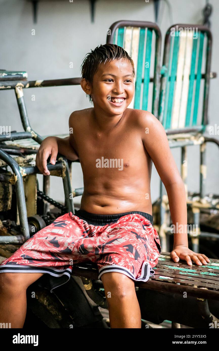 A young Filipino boy poses after a break from the rain in the Tondo ...