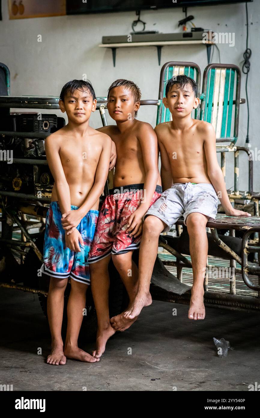 Young Filipino boys pose after a break from the rain in the Tondo ...