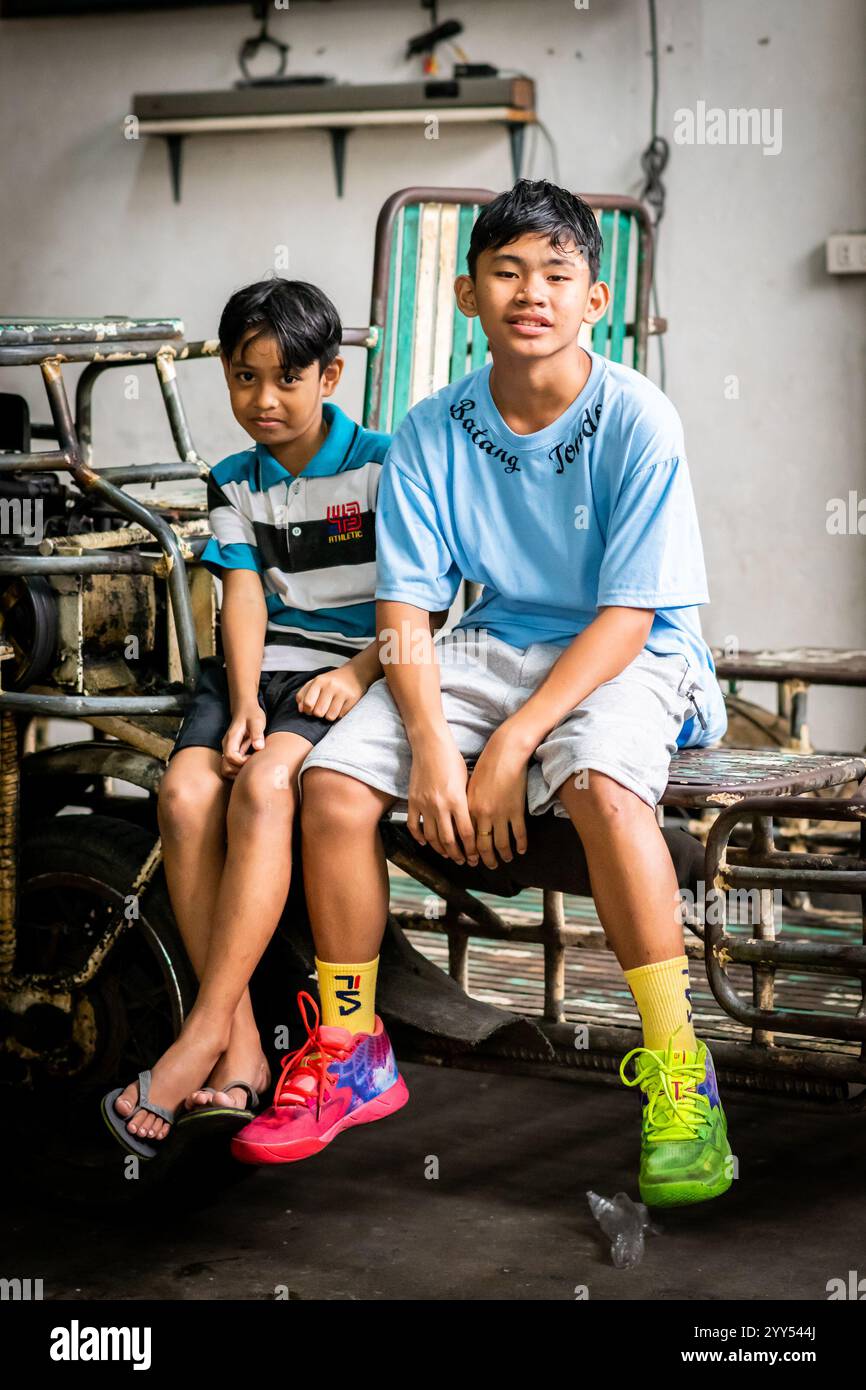 Young Filipino boys pose after a break from the rain in the Tondo District of Manila The ...