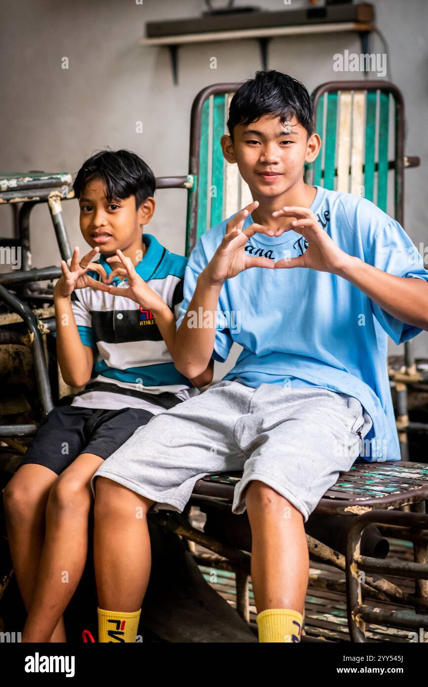 Young Filipino boys pose after a break from the rain in the Tondo District of Manila The ...
