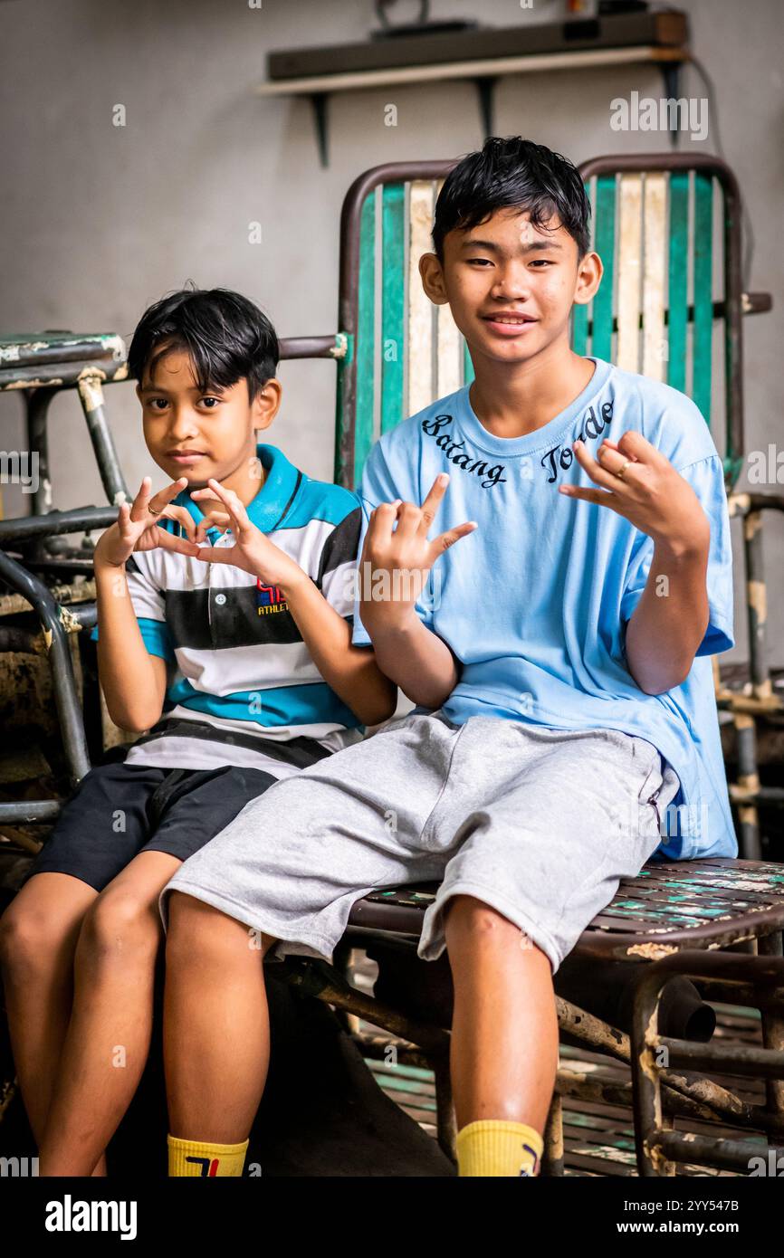 Young Filipino boys pose after a break from the rain in the Tondo District of Manila The ...