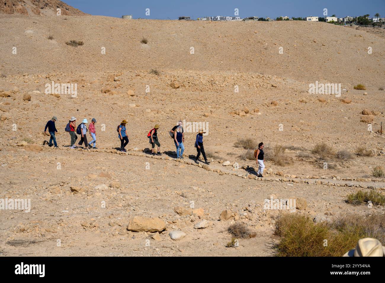 Hikers hiking to the Caves in the Marl cliff at Qumran archeological ...
