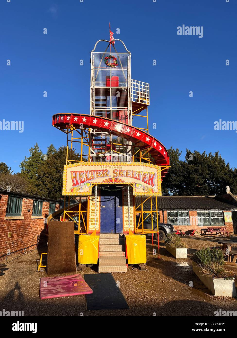 Fun fair Helter Skelter slide ride with blue sky and sunshine Stock ...