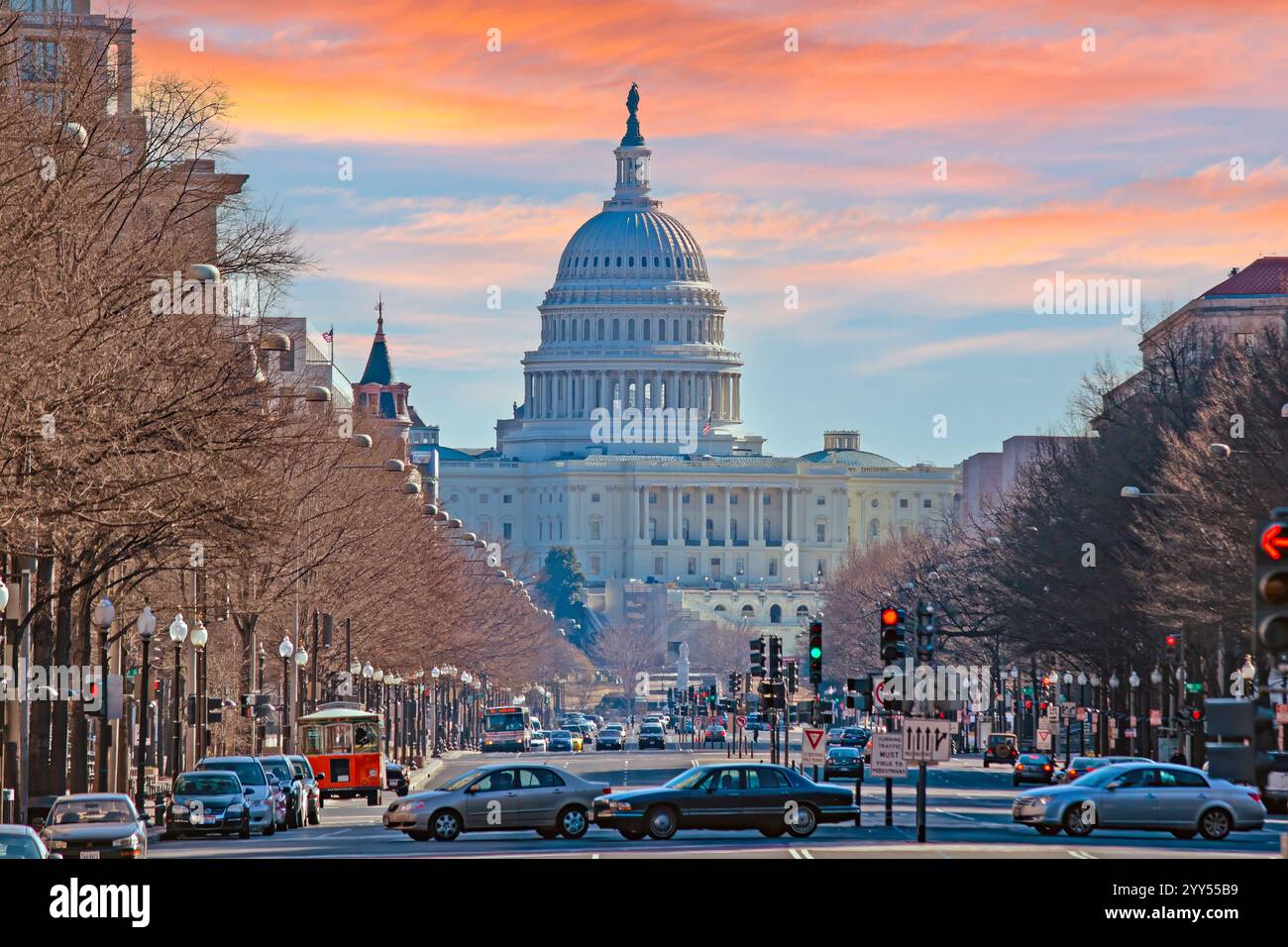 The US Capitol Dome overlooking a busy street with traffic under a ...