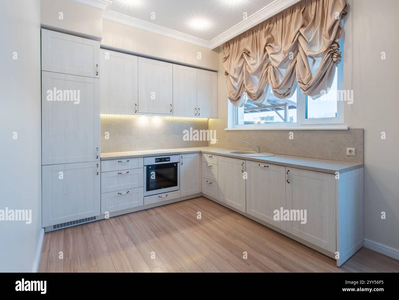 Bright stylish kitchen interior, wooden cabinetry, modern appliances ...