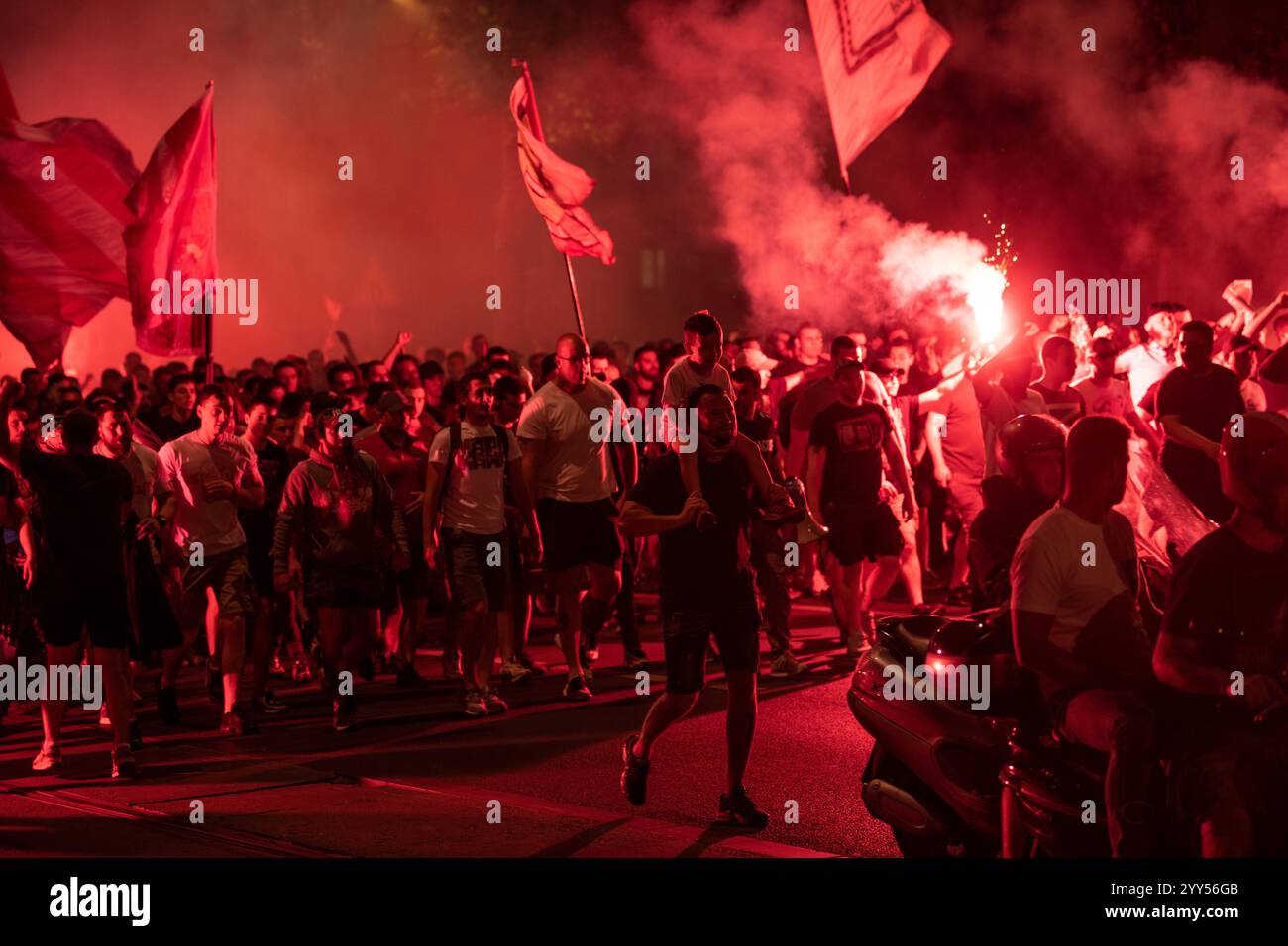 Red Star Football fans with torches and flags marching on streets and ...
